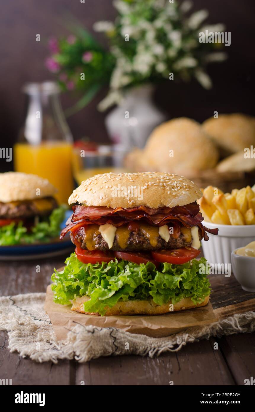 Homemade bacon burger with lettuce and cheddar, homemade potato french ...