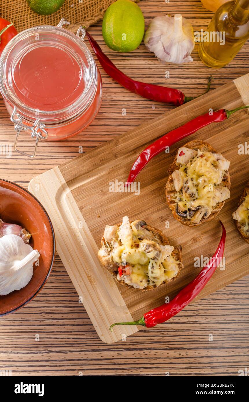 Devil toast with chicken meat and chilli, cheese gratin Stock Photo - Alamy
