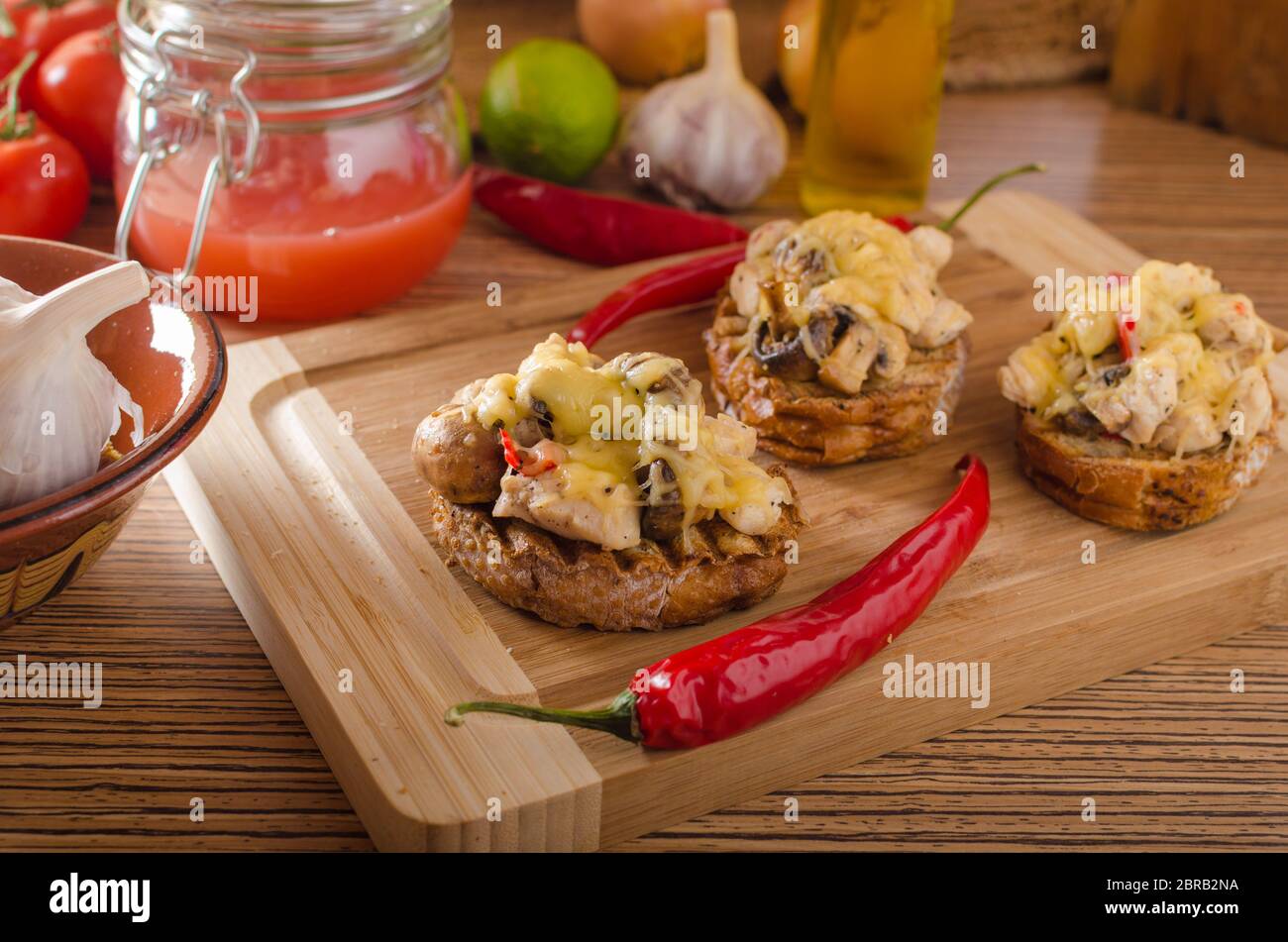 Devil toast with chicken meat and chilli, cheese gratin Stock Photo - Alamy