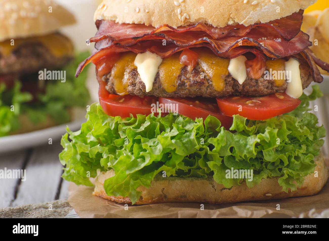 Homemade bacon burger with lettuce and cheddar, homemade potato french ...