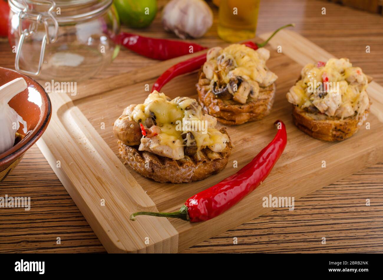 Devil toast with chicken meat and chilli, cheese gratin Stock Photo - Alamy