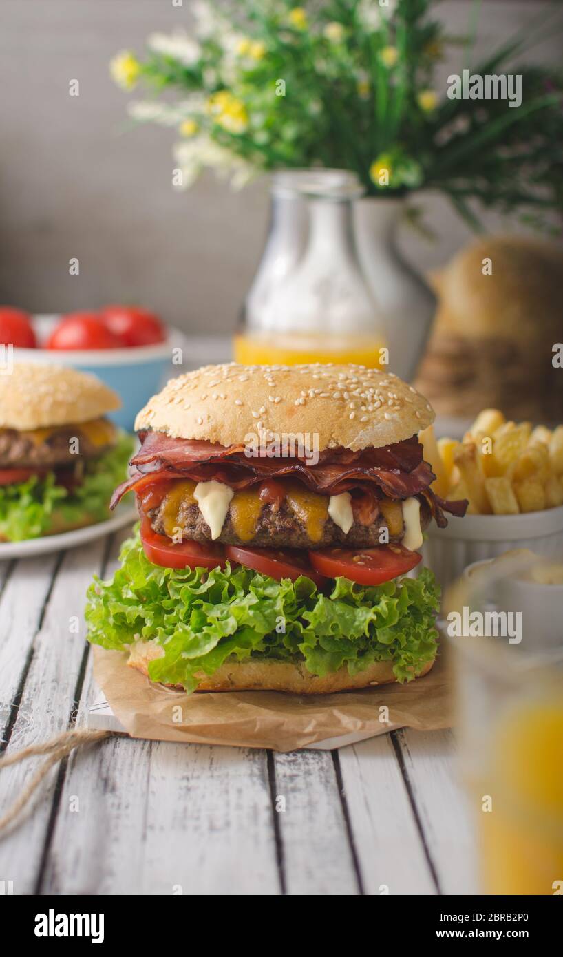 Homemade bacon burger with lettuce and cheddar, homemade potato french ...