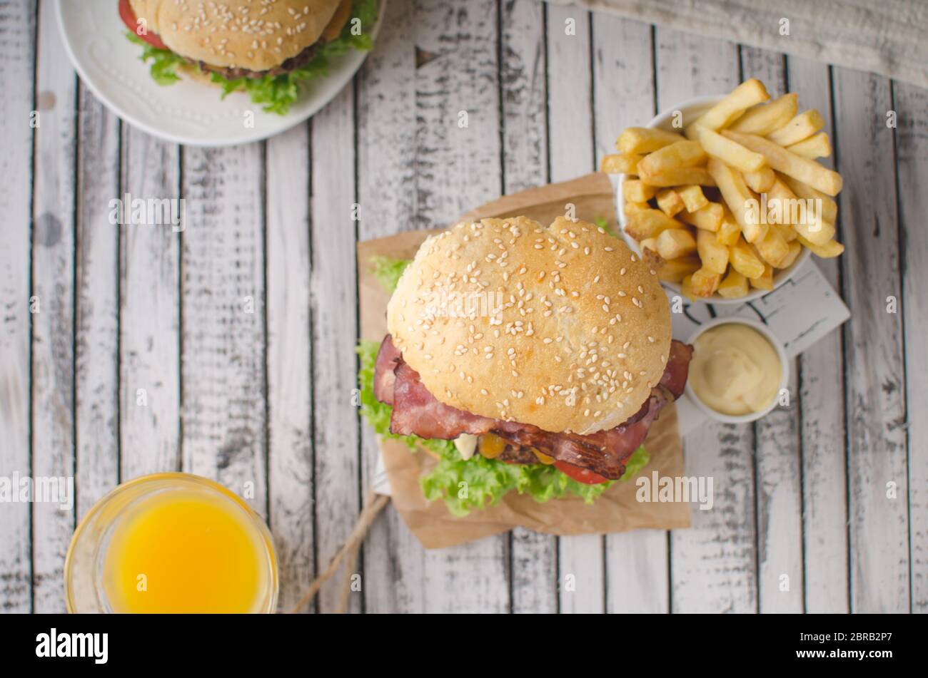 Homemade bacon burger with lettuce and cheddar, homemade potato french ...