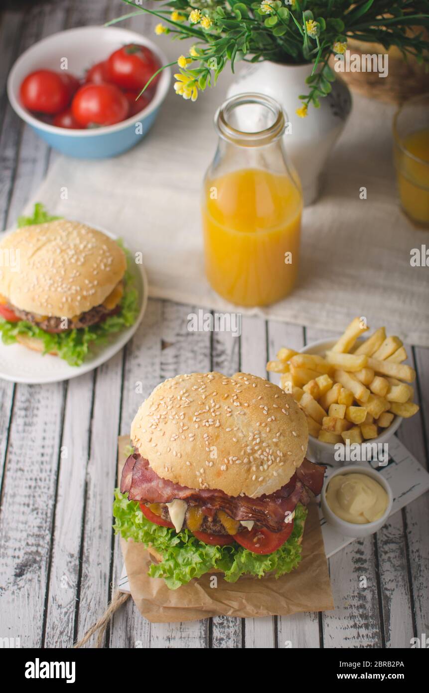 Homemade bacon burger with lettuce and cheddar, homemade potato french ...