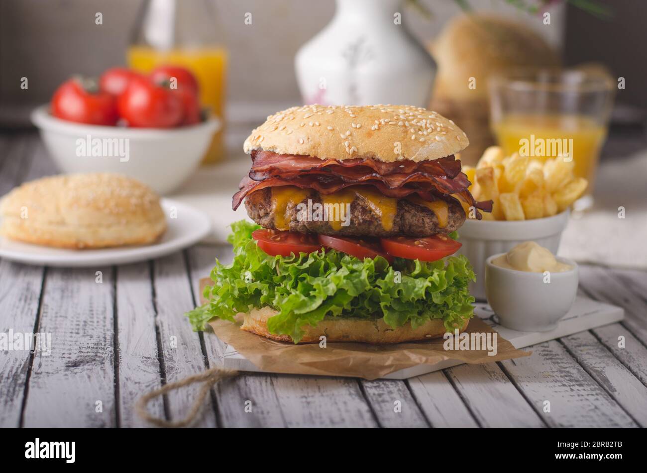 Homemade bacon burger with lettuce and cheddar, homemade potato french ...