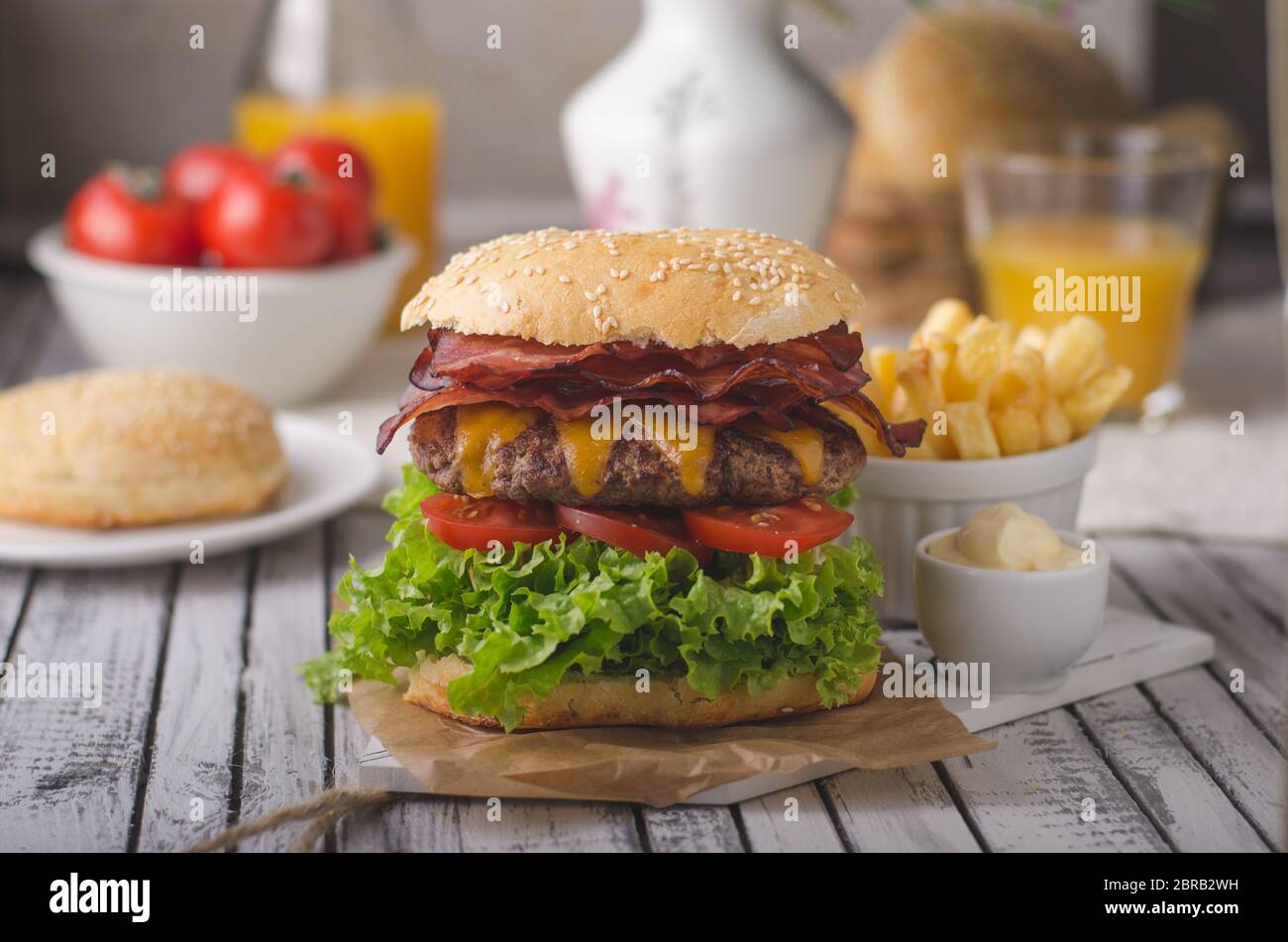 Homemade bacon burger with lettuce and cheddar, homemade potato french ...