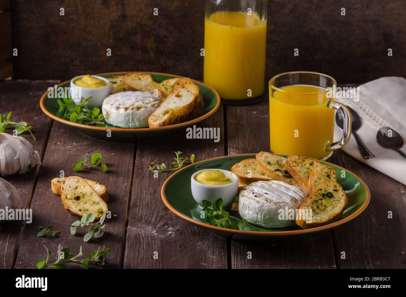 Grilled camembert with toast and juice, fresh toasted baquette with ...