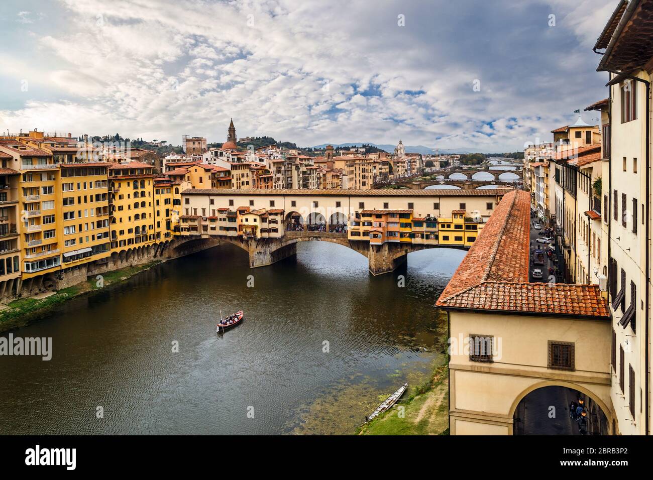 The Ponte Vecchio, famous medieval stone bridge over the Arno River in ...