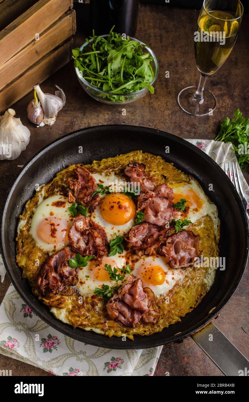 American Hash Browns potato with fried egg, bacon and herbs, real ...