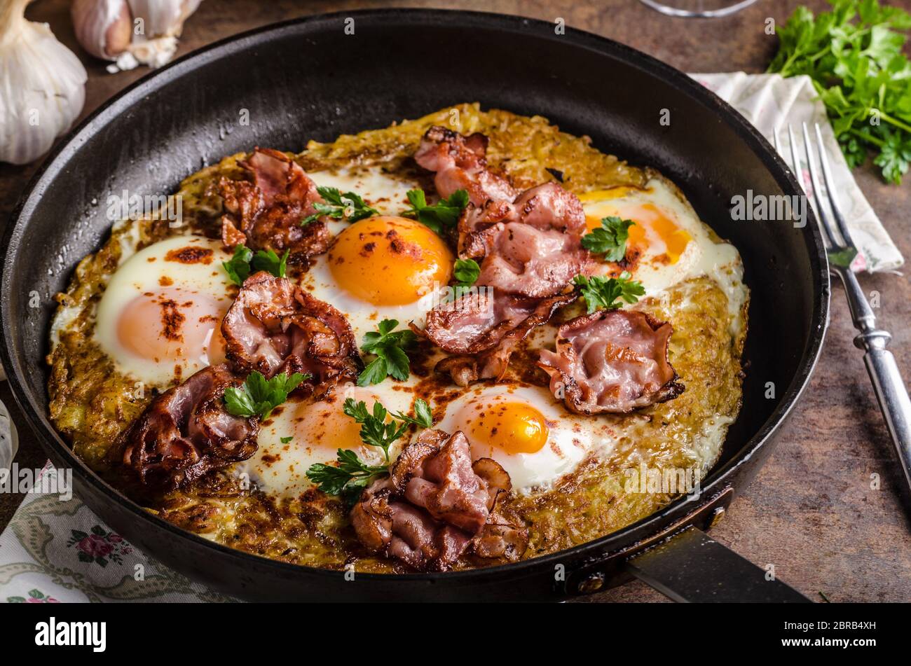 American Hash Browns potato with fried egg, bacon and herbs, real ...