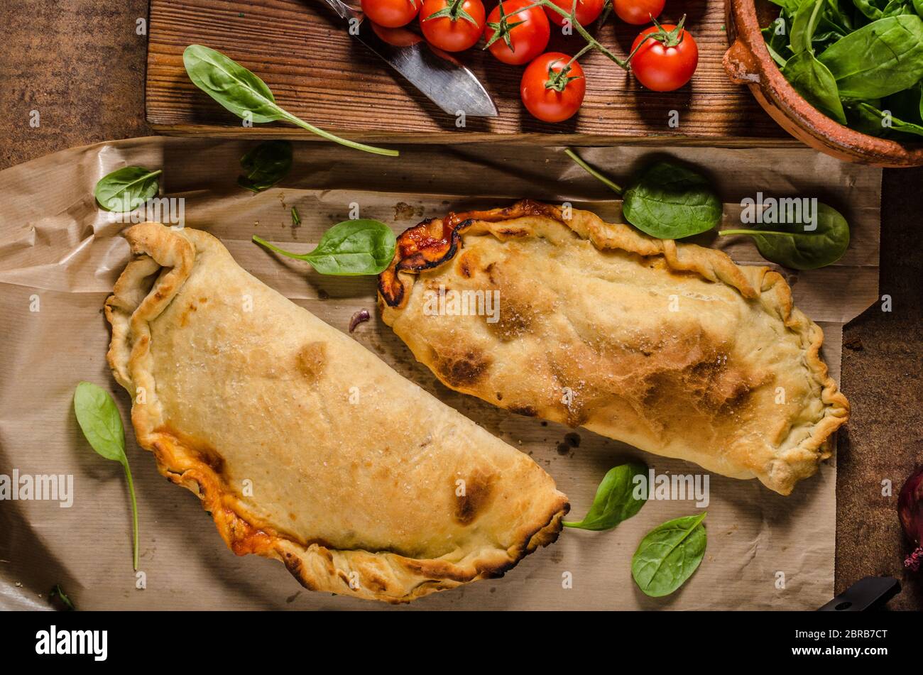 Calzone pizza, stuffed with tomato and herbs sauce, baked to crispy Stock Photo - Alamy