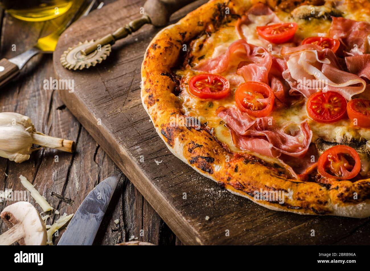 Rustic old style vintage pizza, wood board, fresh food Stock Photo - Alamy
