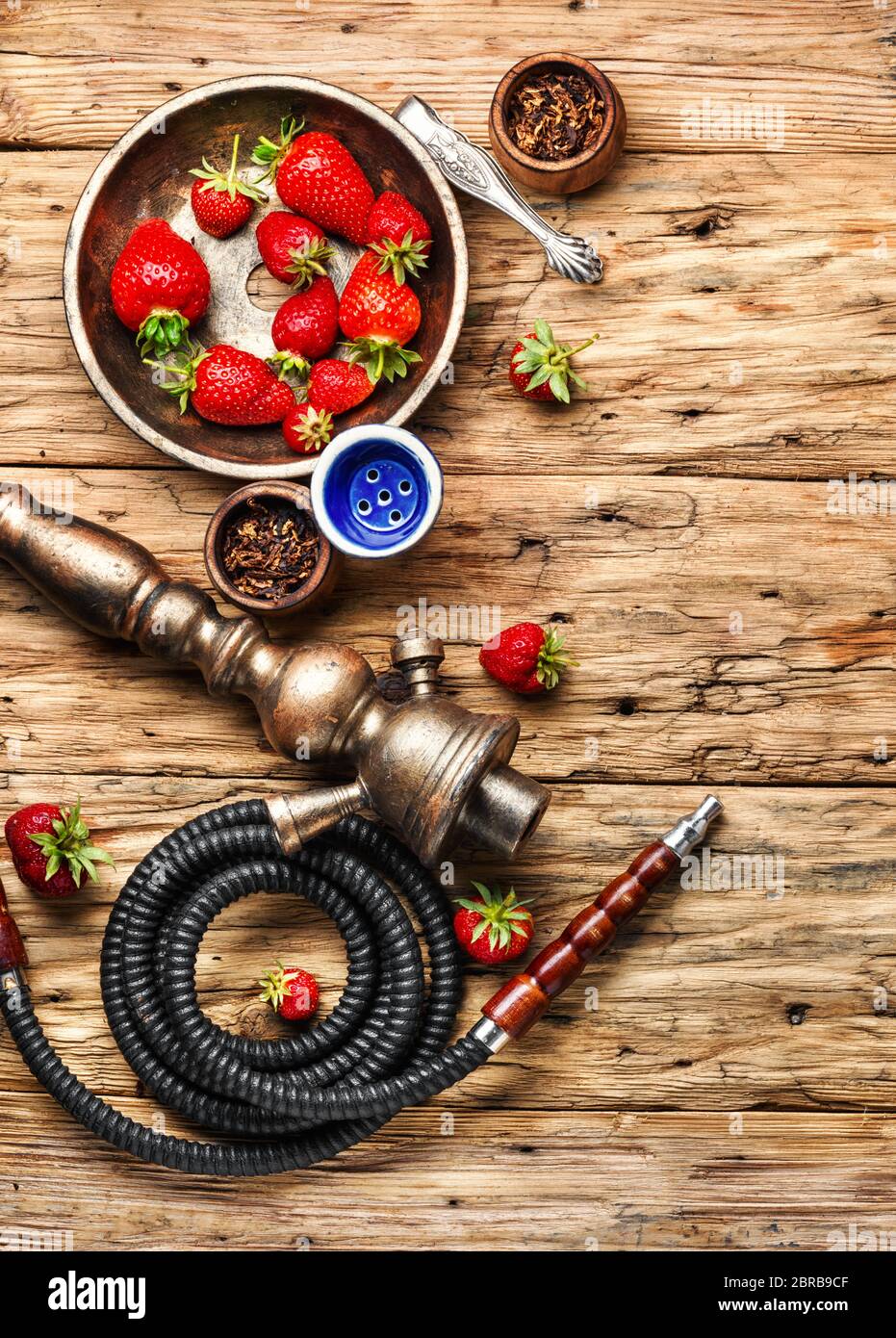 East smoking shisha with tobacco with strawberry flavor Stock Photo - Alamy