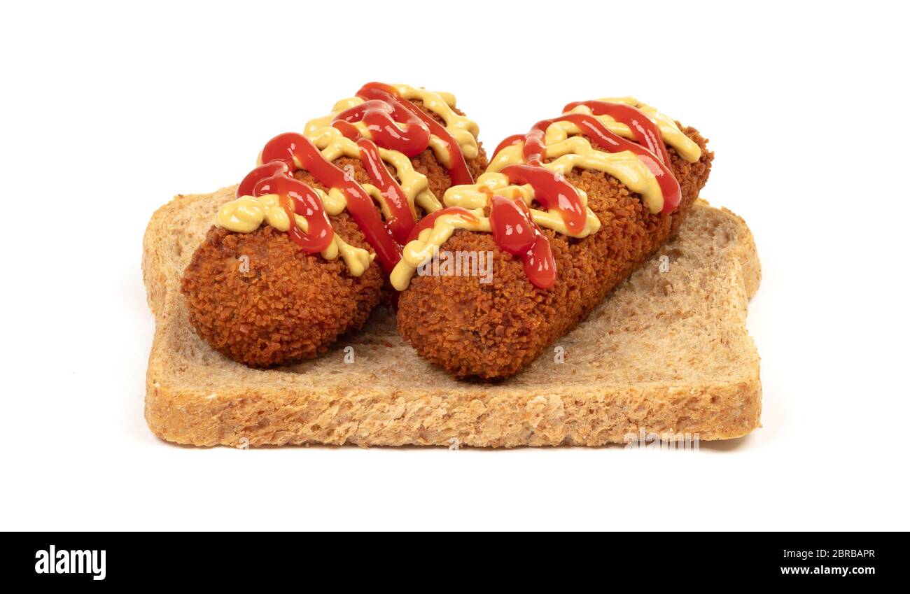Brown crusty dutch kroket with mustard topping isolated, on a piece of ...