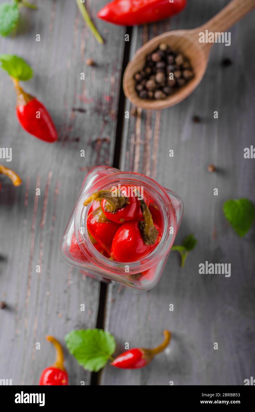 Fresh chilli pepper in bowl with herbs Stock Photo - Alamy