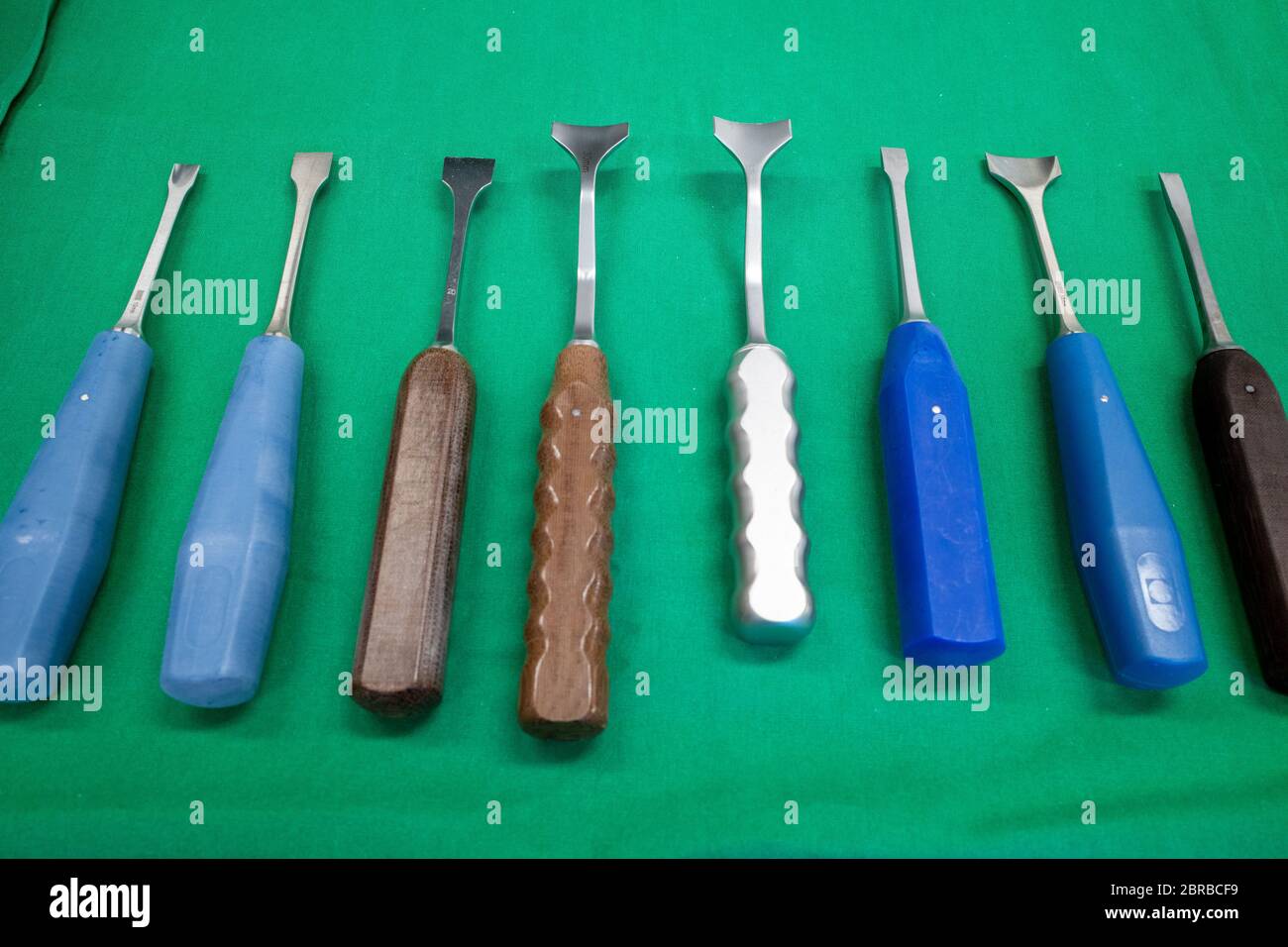 different surgical chisels lie side by side on a surgical drape Stock ...