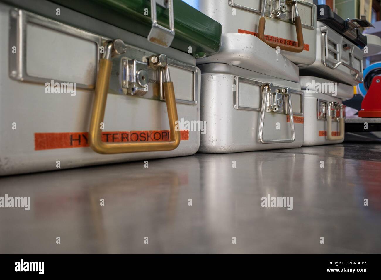 in a sterilization department instrument containers are stacked next to ...