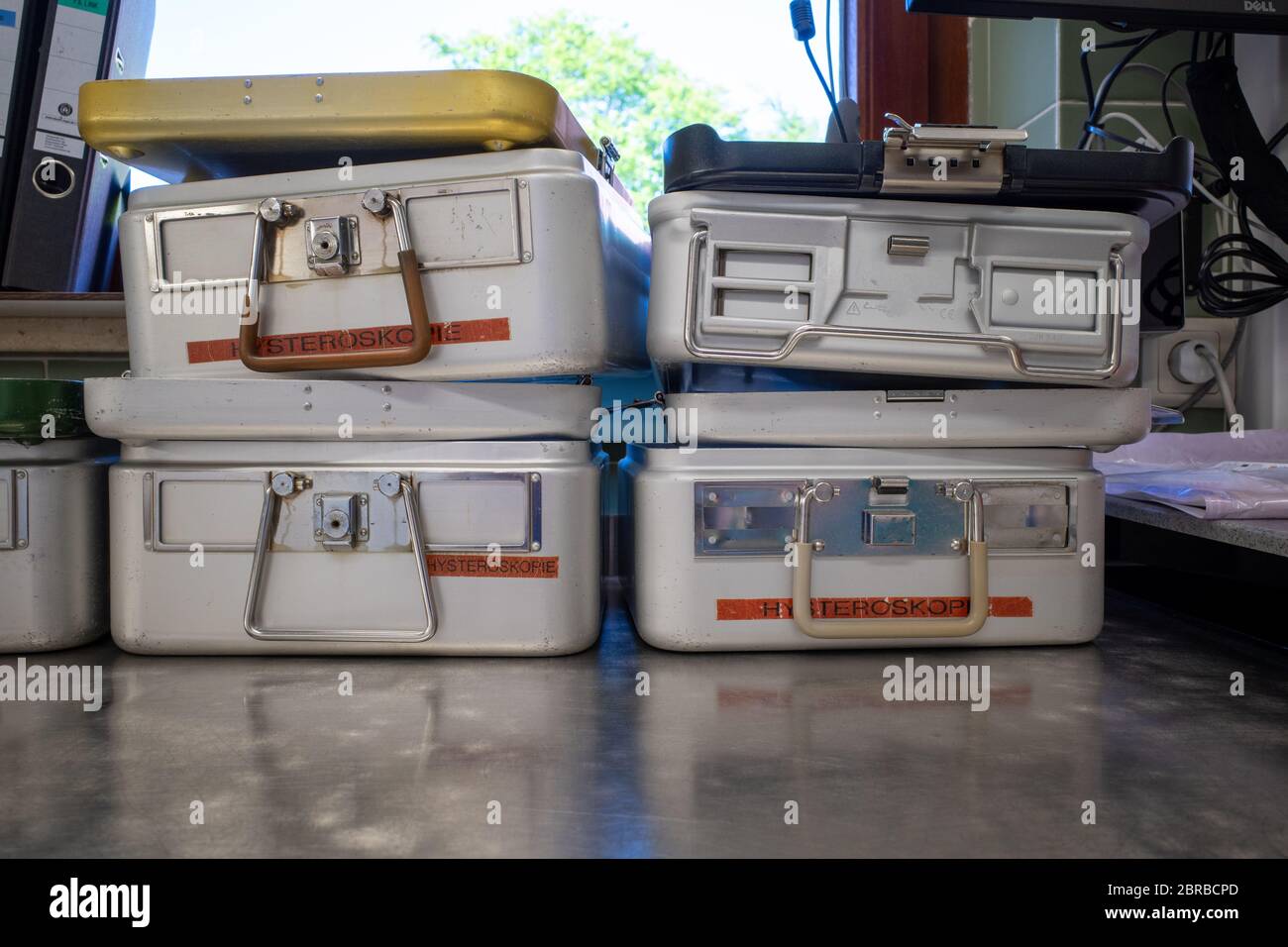in a sterilization department instrument containers are stacked next to ...