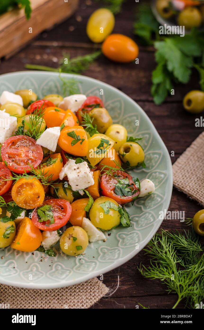 Fresh tomato olives salad, herbs and feta cheese inside Stock Photo - Alamy