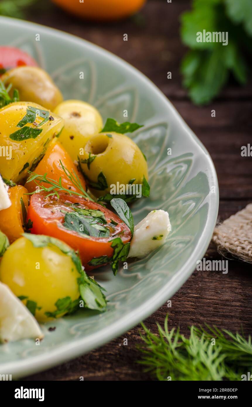 Fresh tomato olives salad, herbs and feta cheese inside Stock Photo - Alamy