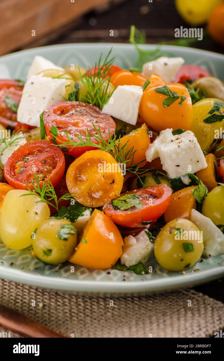 Fresh tomato olives salad, herbs and feta cheese inside Stock Photo - Alamy