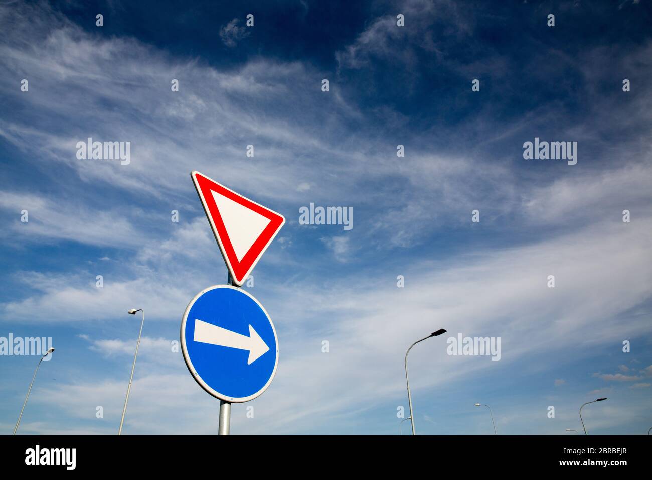 Road signs against lovely blue summer sky Stock Photo - Alamy