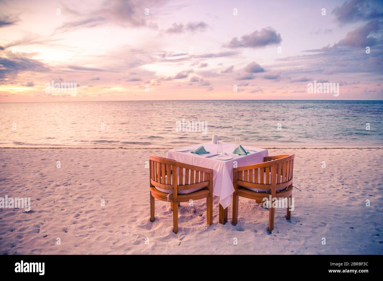 Romantic dinner on the beach with sunset for couples. Love dining ...