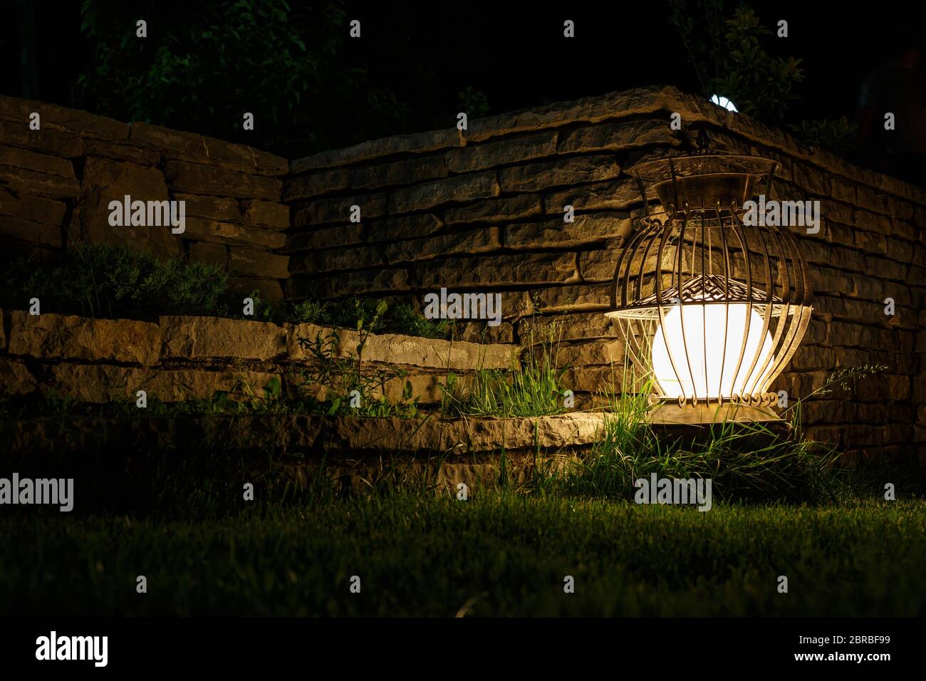 an ancient garden lantern shines in the night . selective focus Stock ...