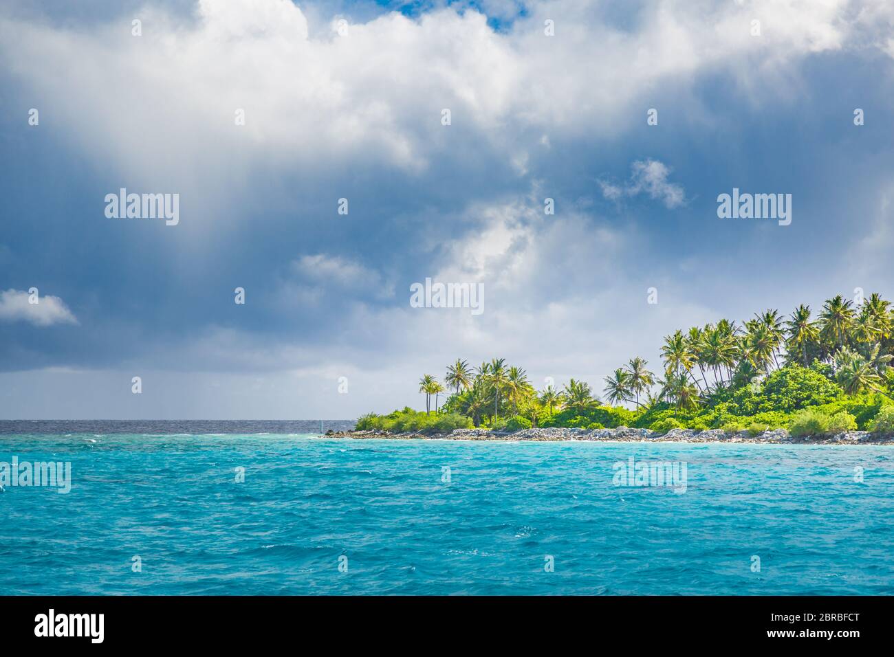 Overcast tropical beach with white sand, palm trees, turquoise ocean ...