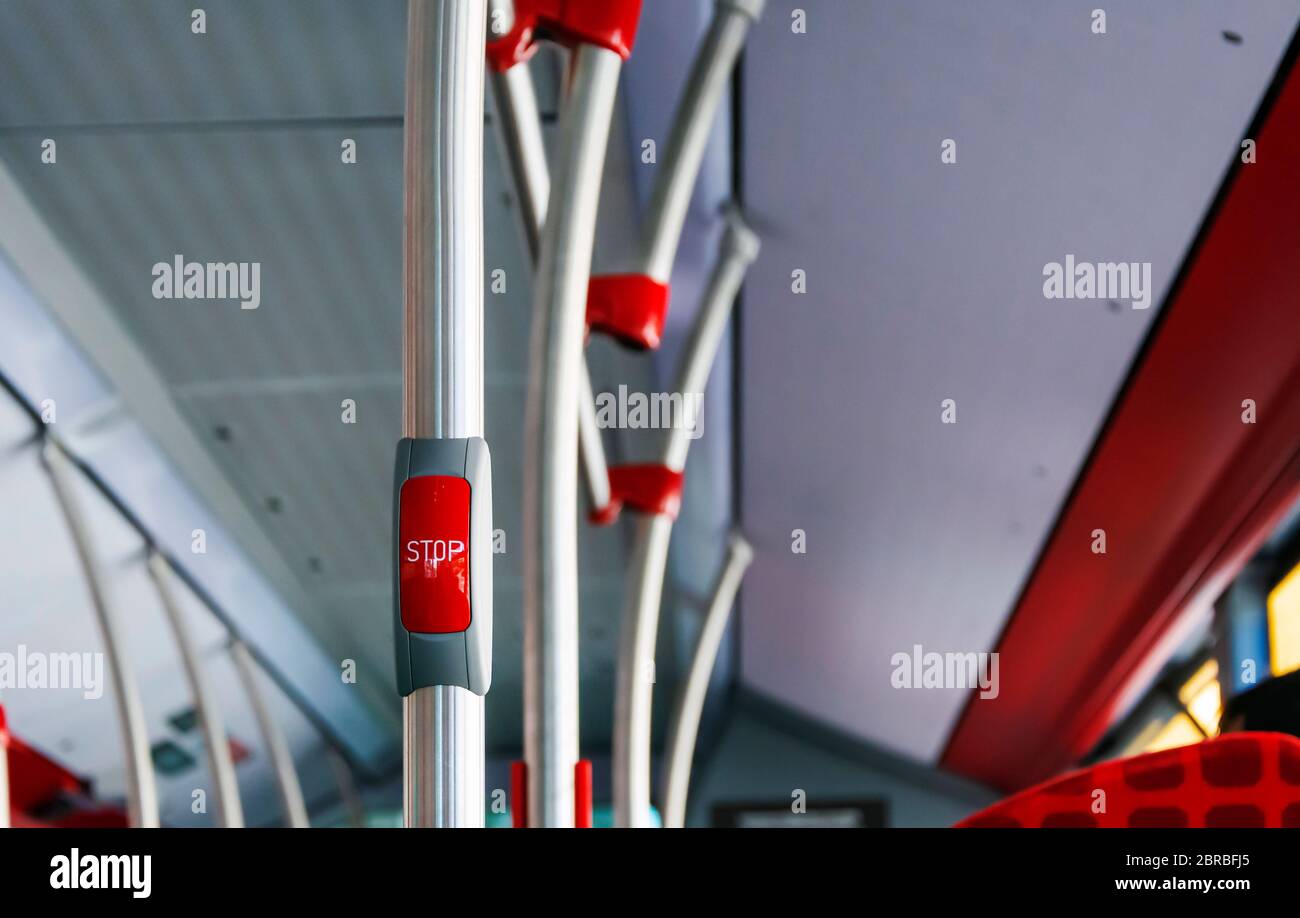 red button to book the stop in a public bus. Public transportation ...