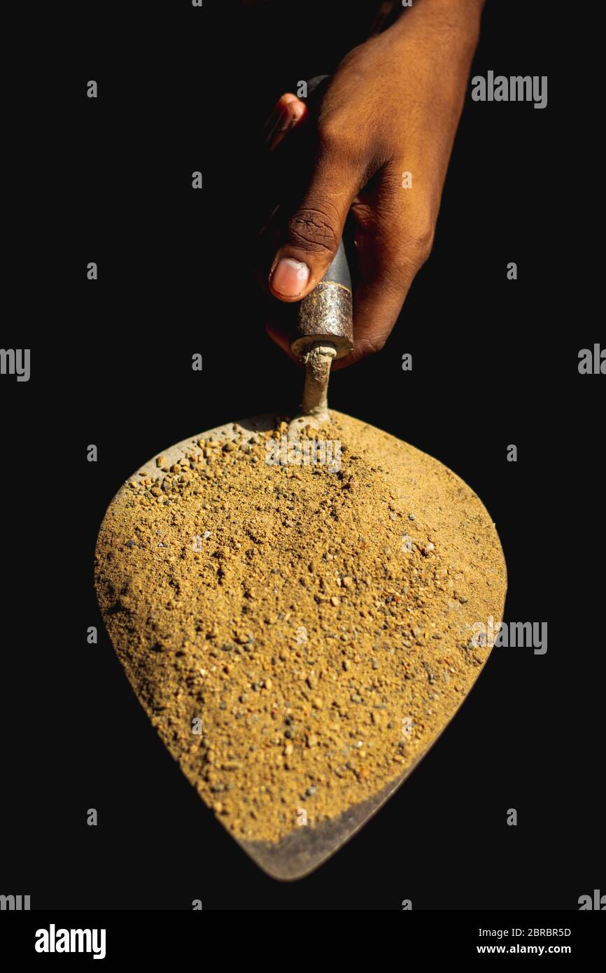 Trowel isolated on Black background. Sand and cement mixed on the ...