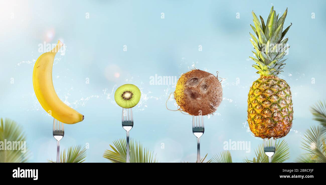Tropical fruits on a fork Stock Photo - Alamy