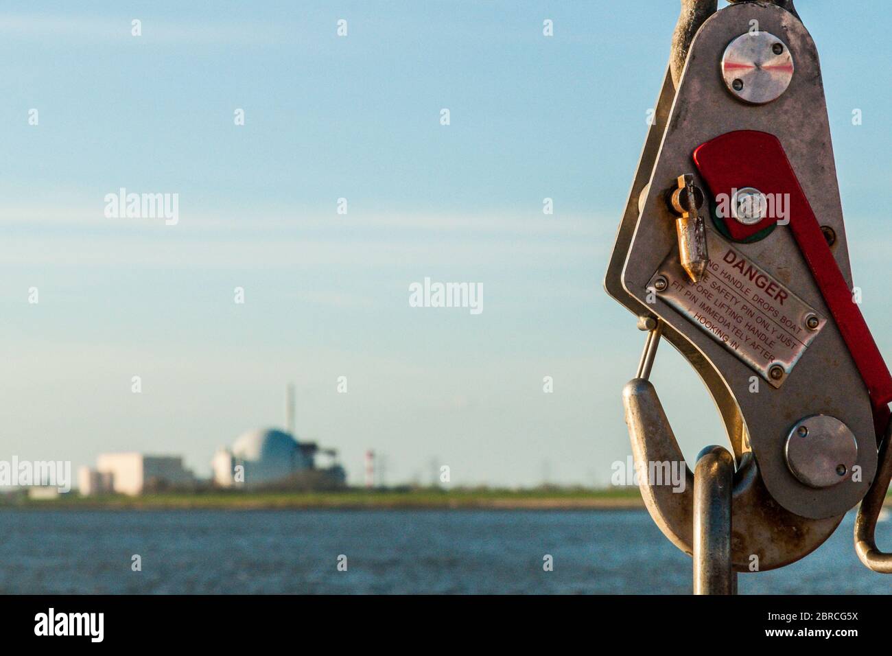A snap hook labeled "Danger" in front of a nuclear power plant Stock ...