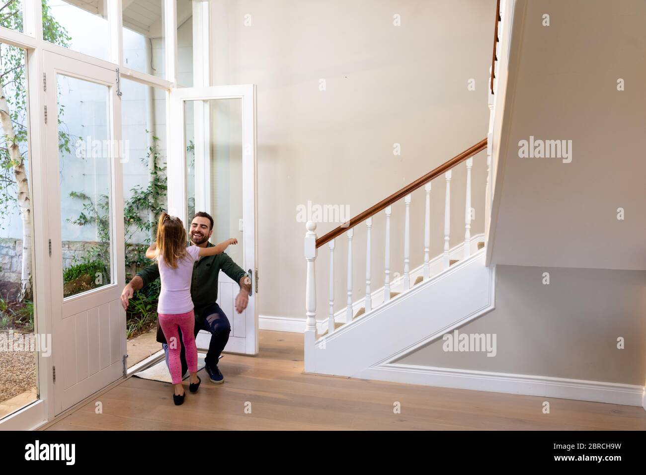 Caucasian man arriving home Stock Photo - Alamy