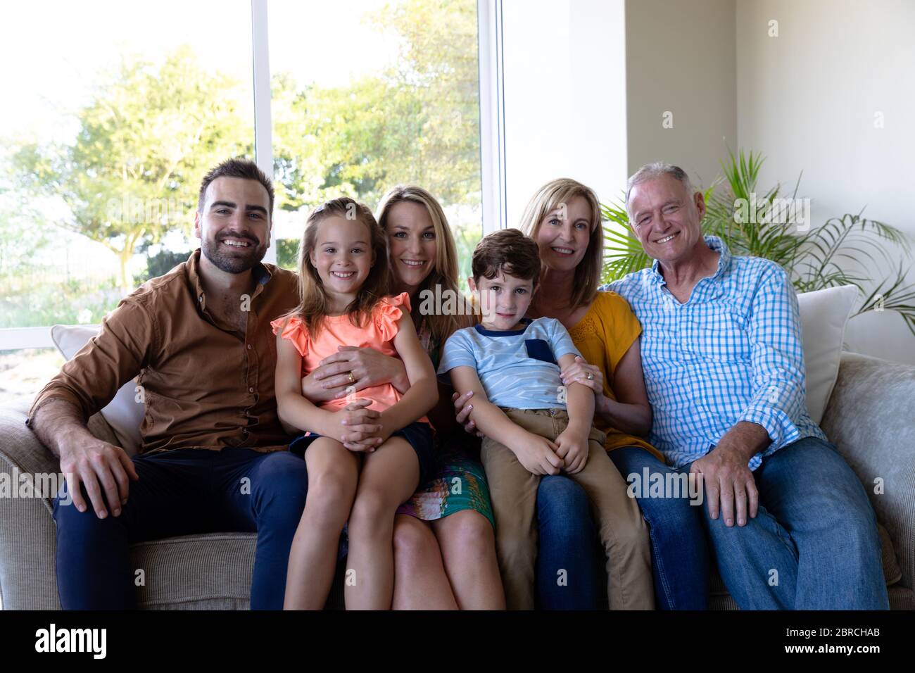 Caucasian family in the living room at home Stock Photo - Alamy
