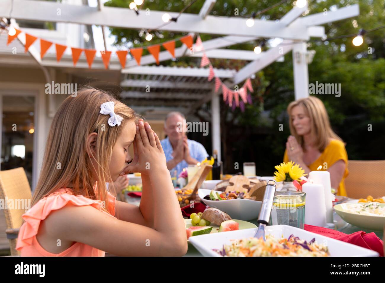 Caucasian family saying grace together before eating Stock Photo - Alamy