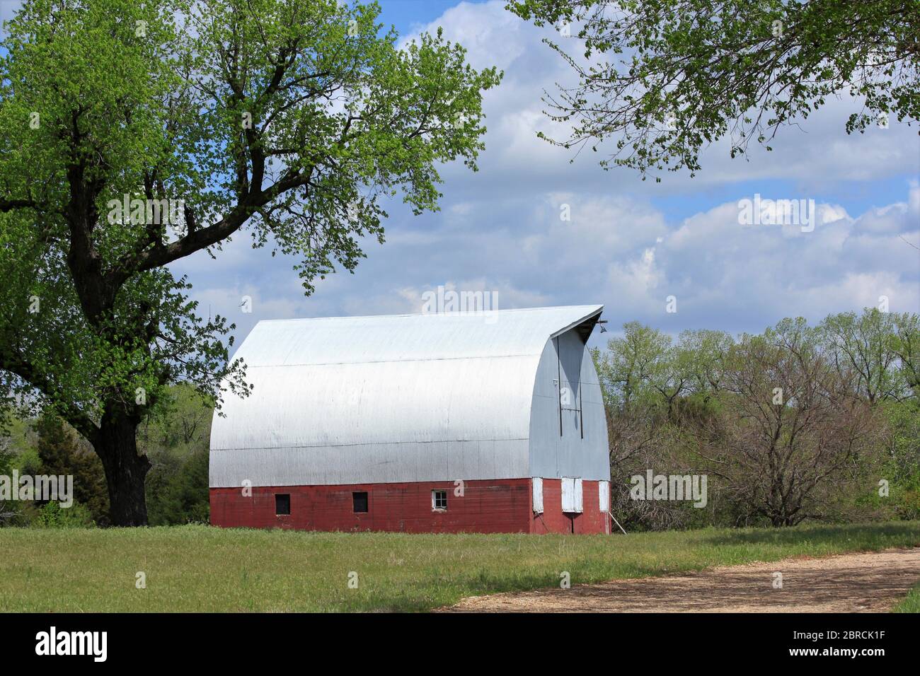 Kansas Red and White Barn with blue sky,white clouds, with tree's and ...