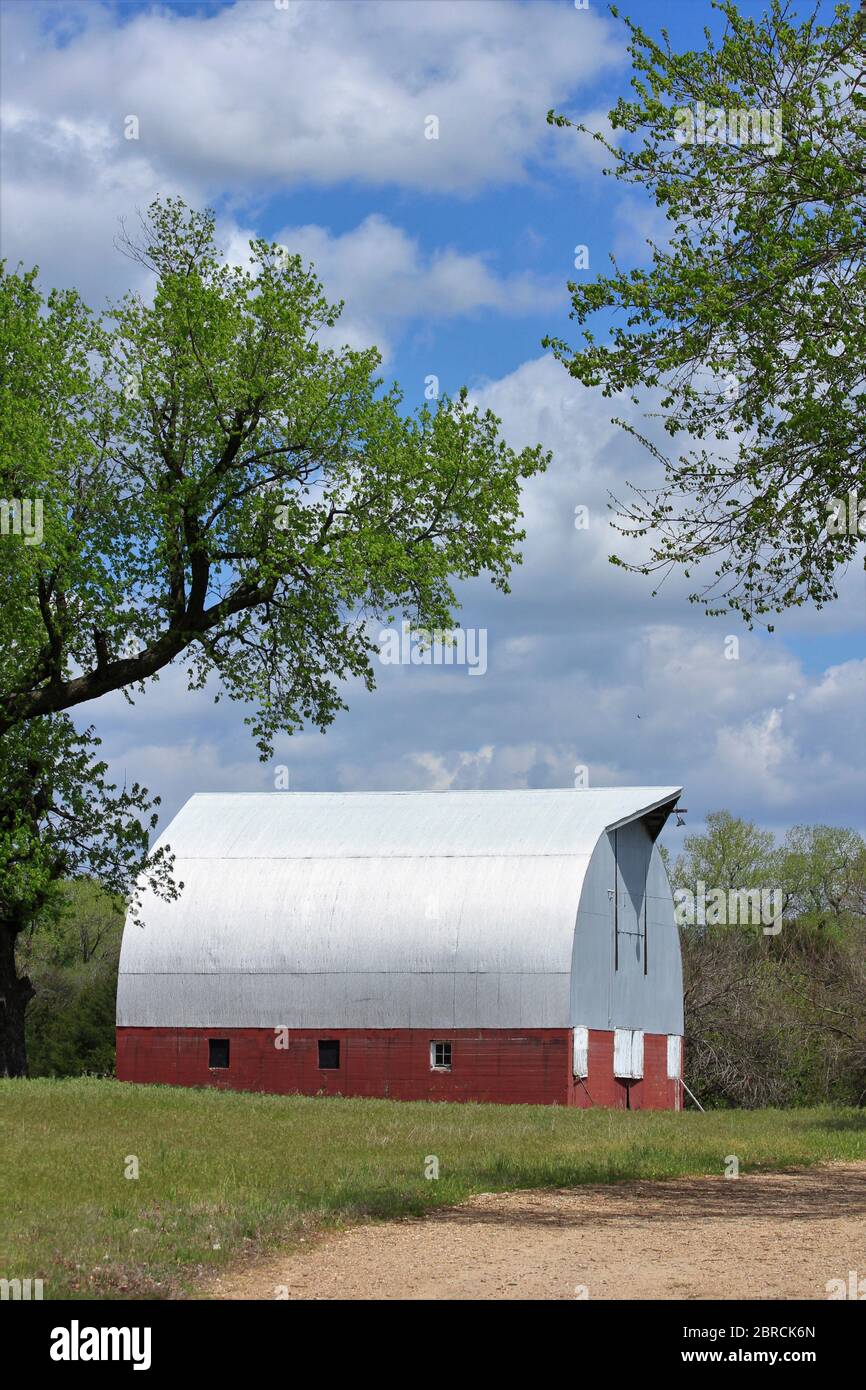 Kansas Red and white barn out in the country with blue sky and white ...