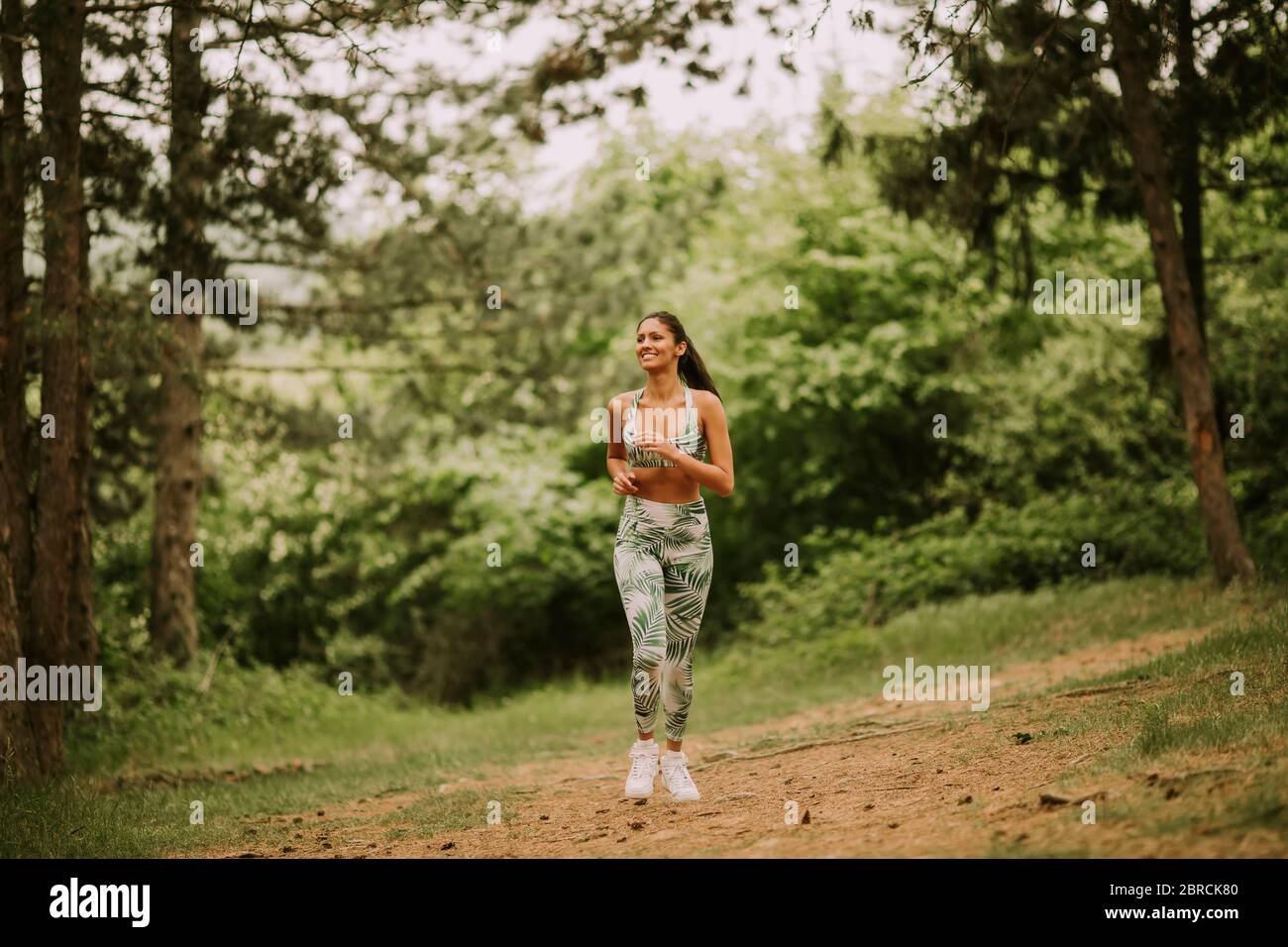 Fitness woman running forest trail hi-res stock photography and images ...