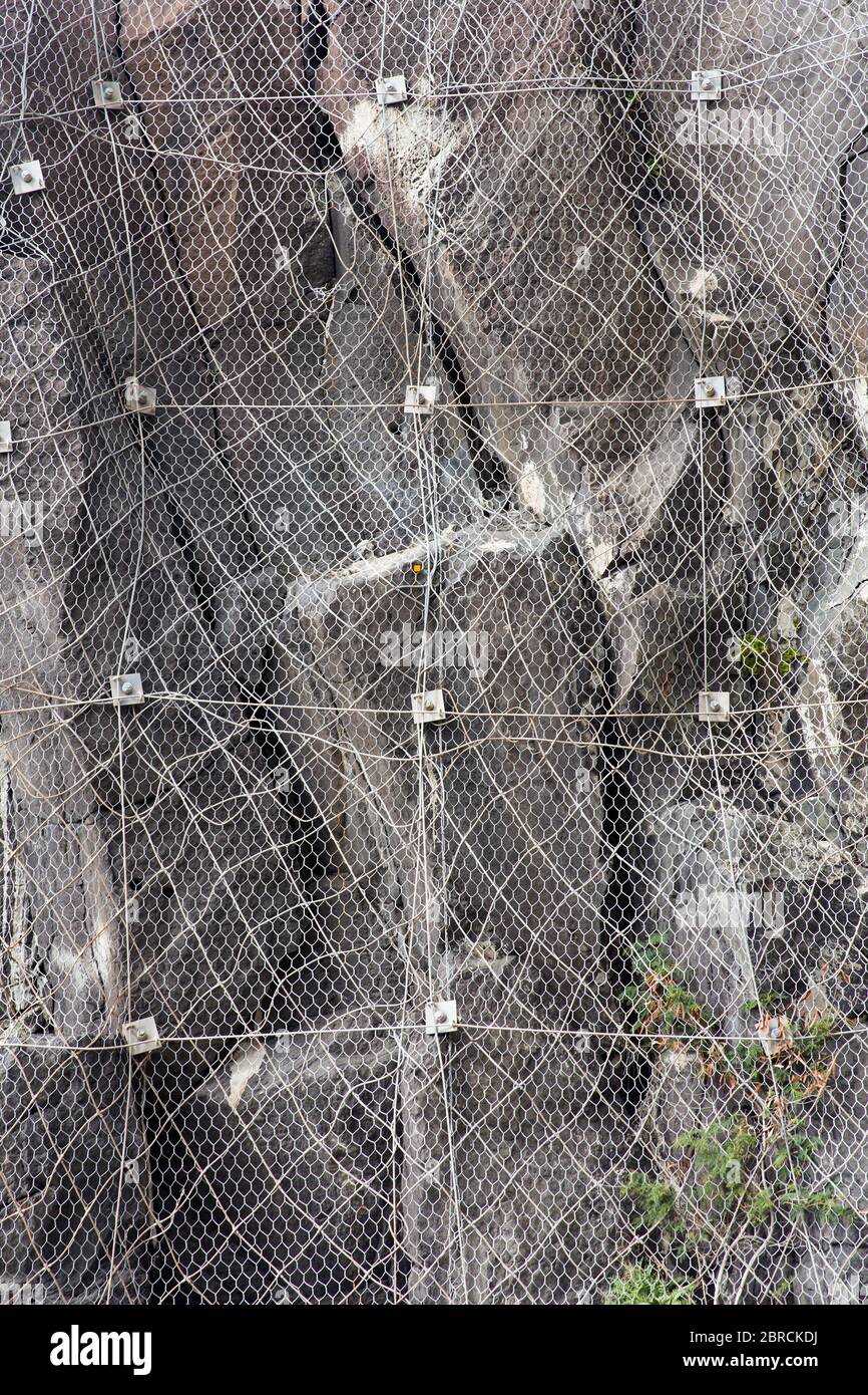 Closeup of slope of the mountain with a rockfall protection net ...