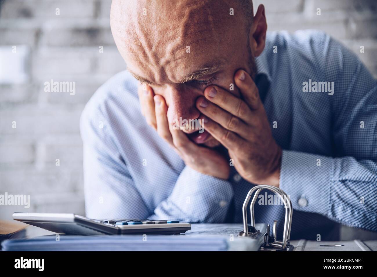 Crying businessman stressed about bankruptcy debt Stock Photo - Alamy
