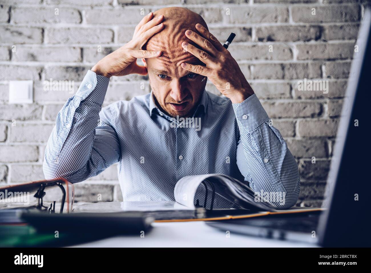 Finacial problems and crisis. Stressed depressed man reading bills and ...