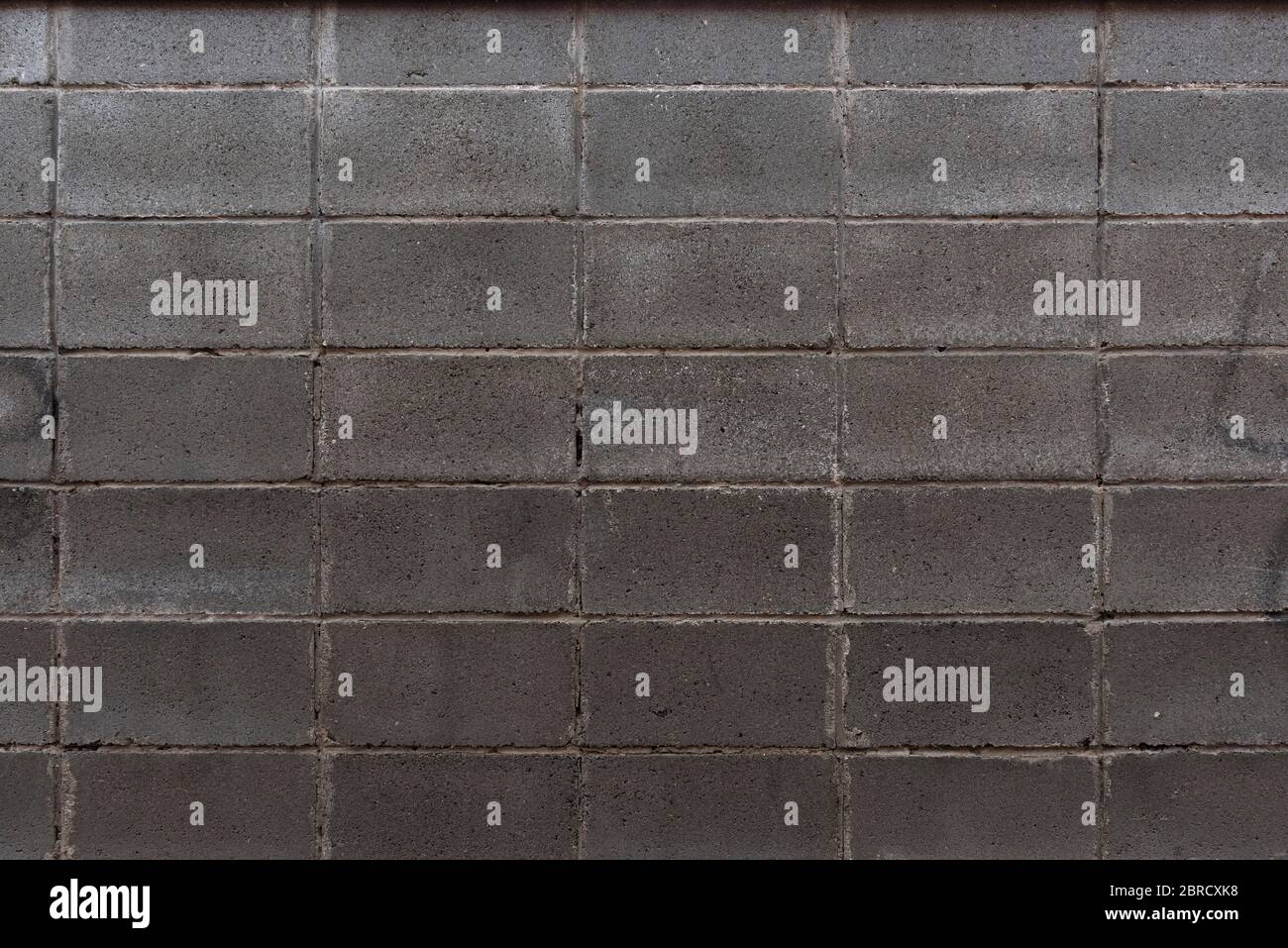 Masonry wall made of gray rectangular stone Stock Photo - Alamy