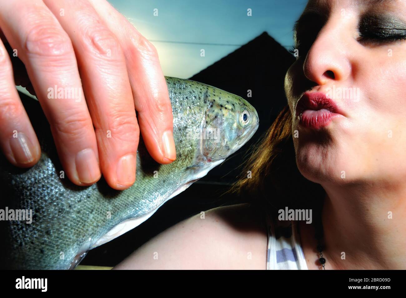 Woman kissing a fish, Corona Series, Germany Stock Photo - Alamy