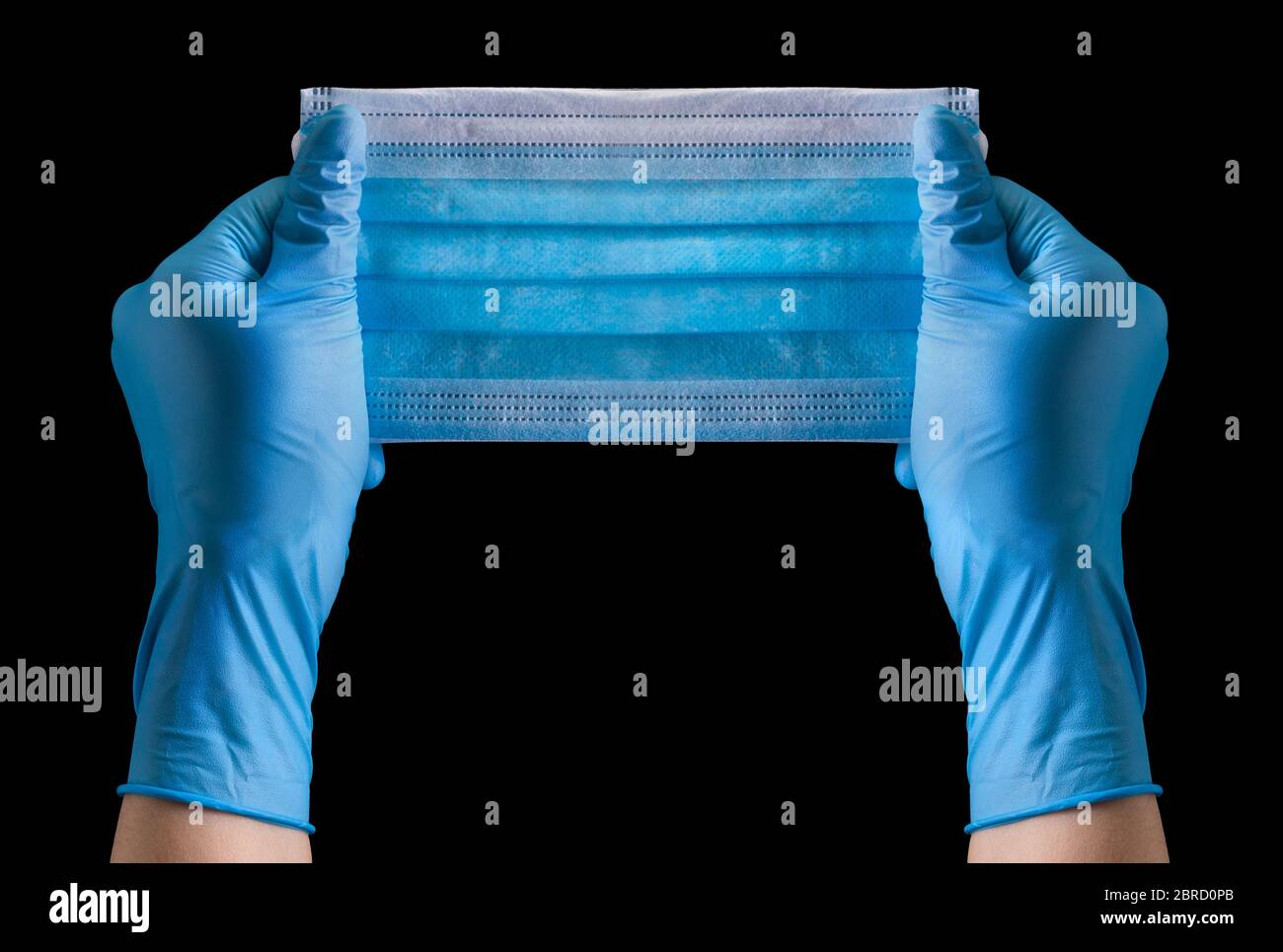Doctor's hand in medical gloves wearing a mask isolated on black Stock ...
