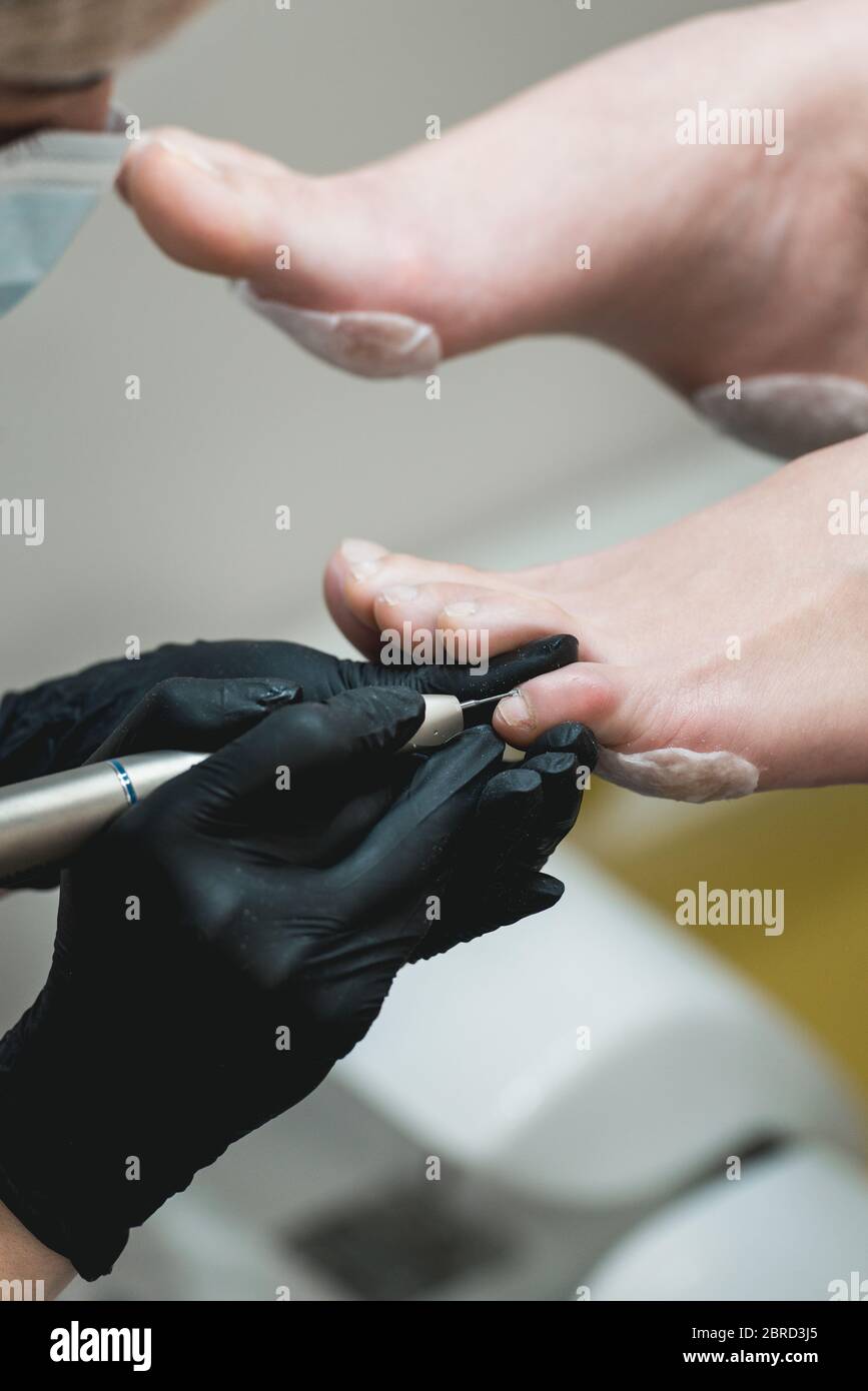 Professional hardware pedicure using electric machine.Patient on ...