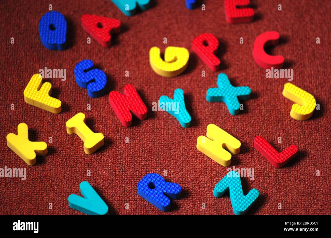 colorful and playful letters on a carpet close up view Stock Photo - Alamy