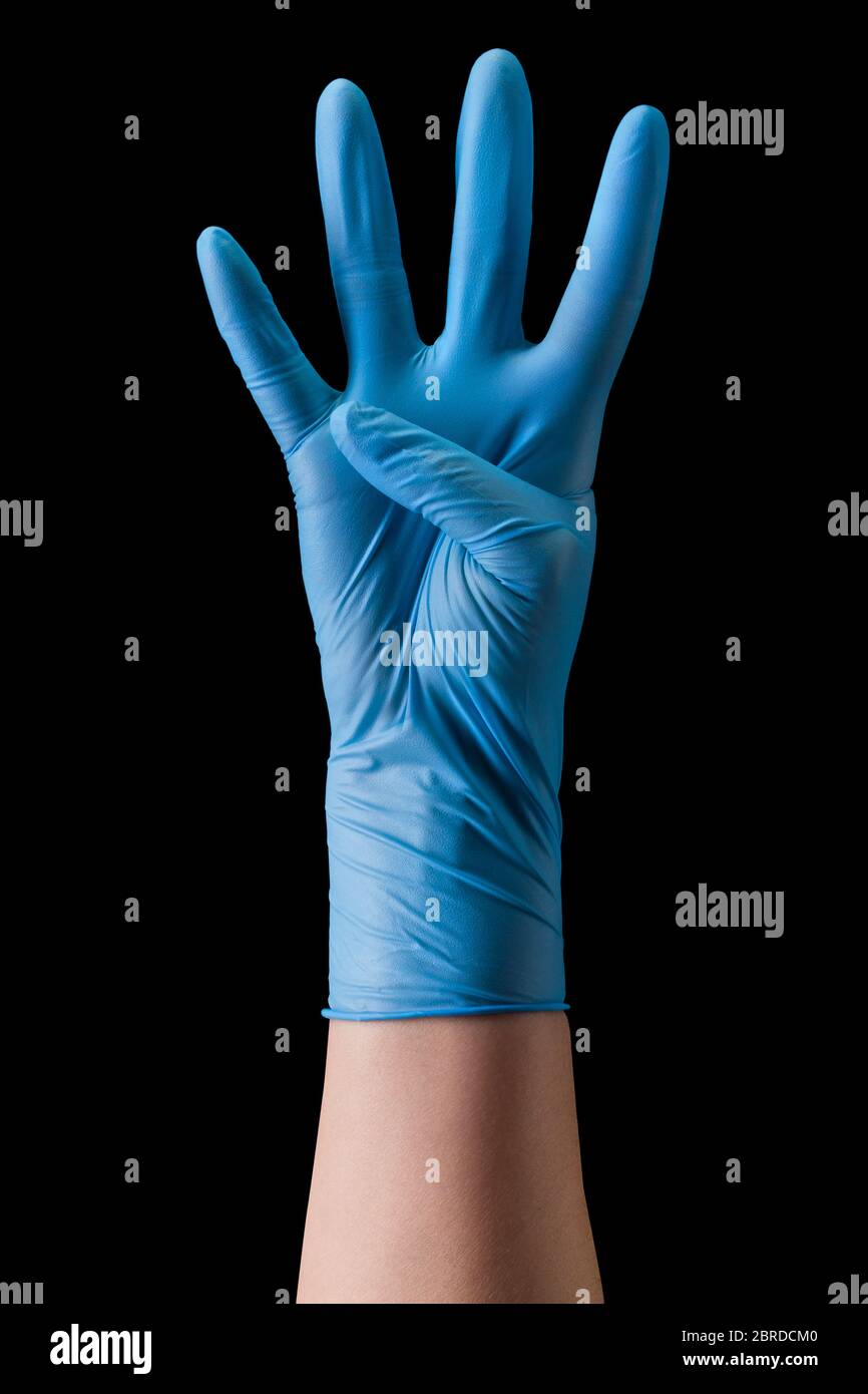 Doctor's hand in medical gloves showing or counting to 4 fingers ...
