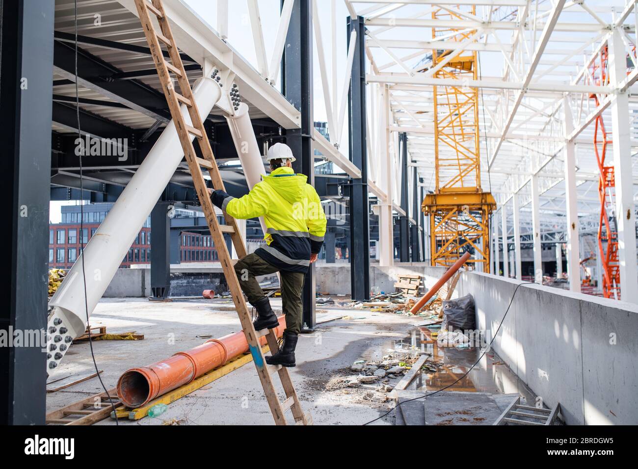 Rear view of man worker outdoors on construction site, working Stock ...