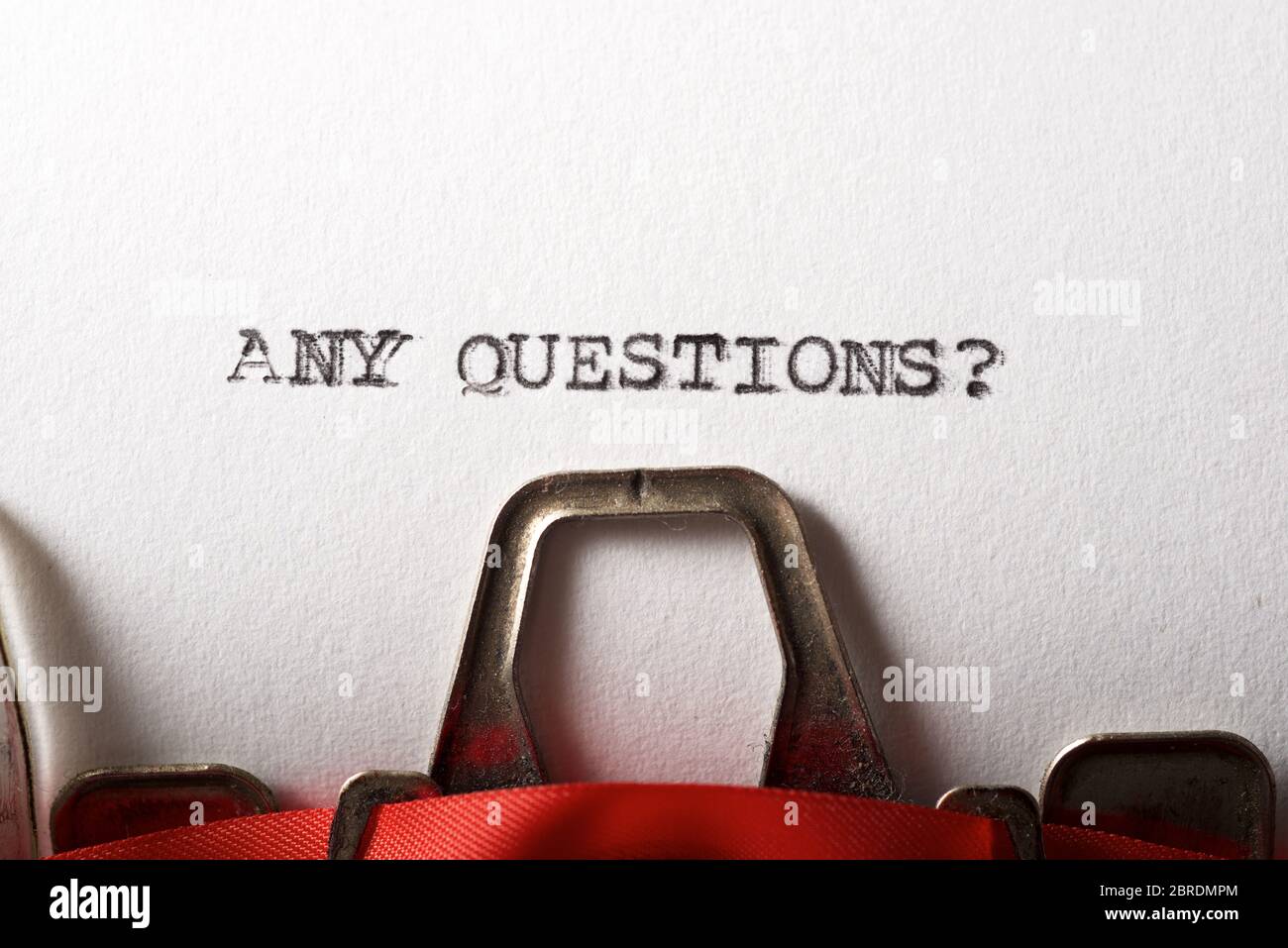 Any questions? text written with a typewriter Stock Photo - Alamy